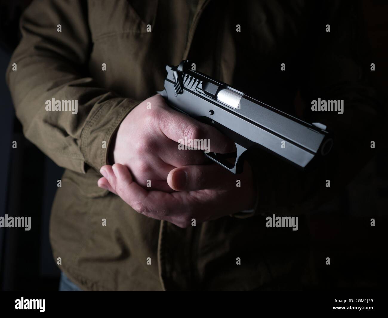Man holding a gun hi-res stock photography and images - Alamy