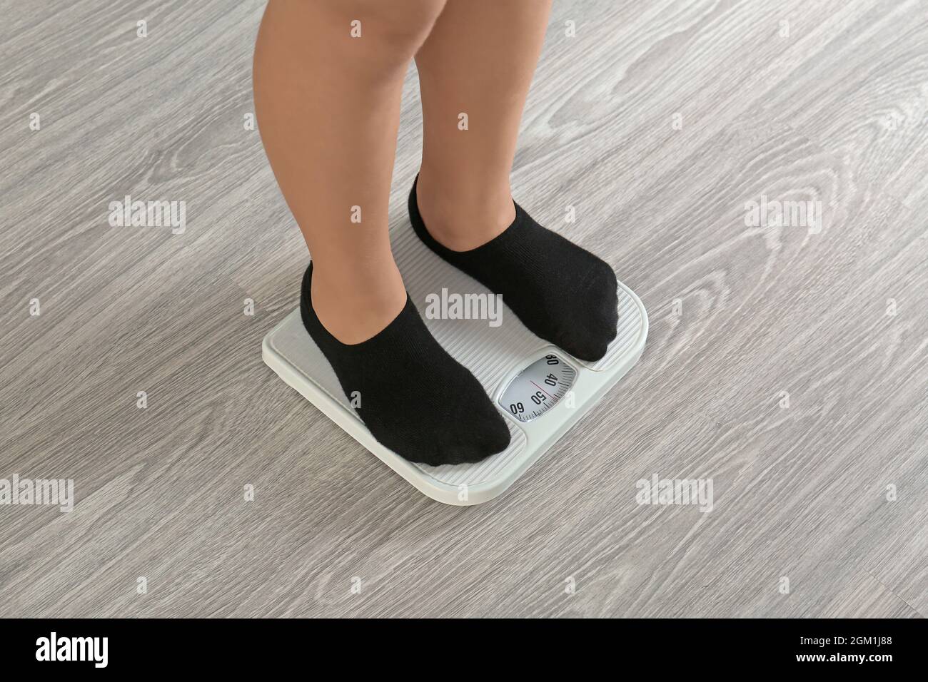 Child obese scales hi-res stock photography and images - Alamy