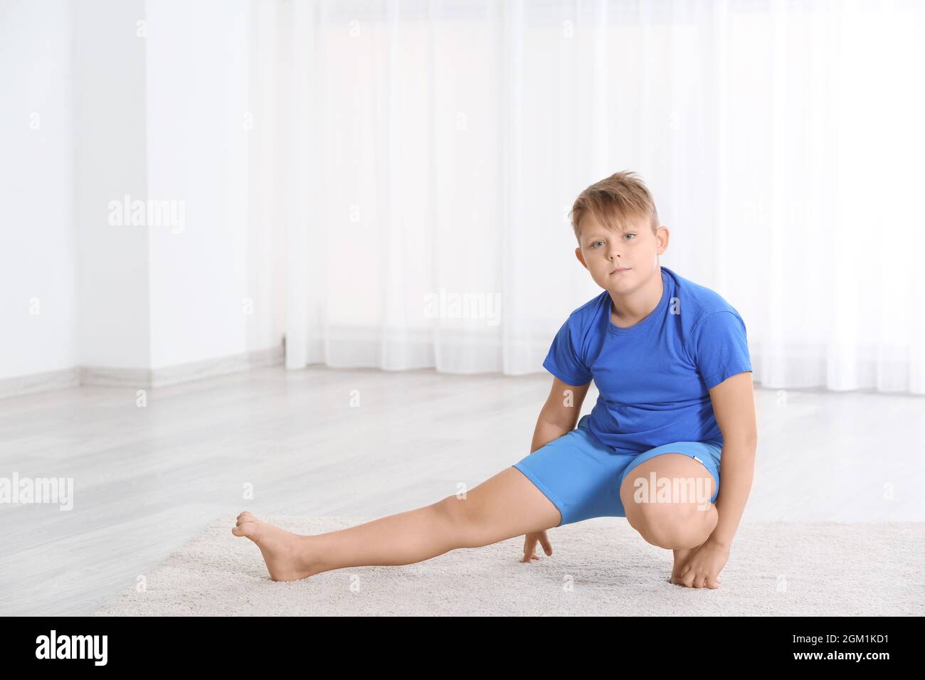Overweight boy training at home Stock Photo - Alamy