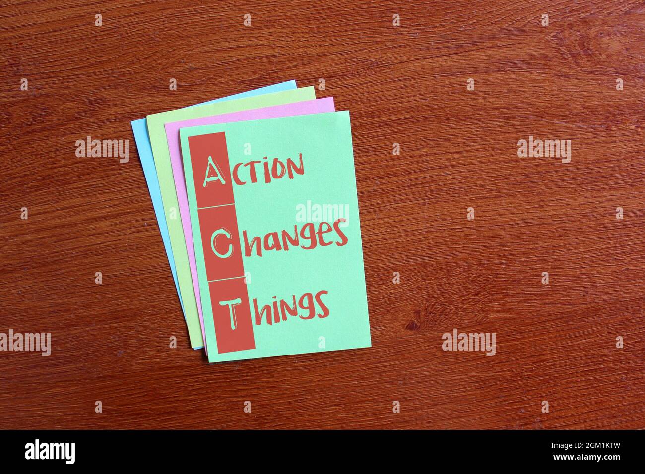Color notepaper with text ACT Action Changes Things Stock Photo - Alamy