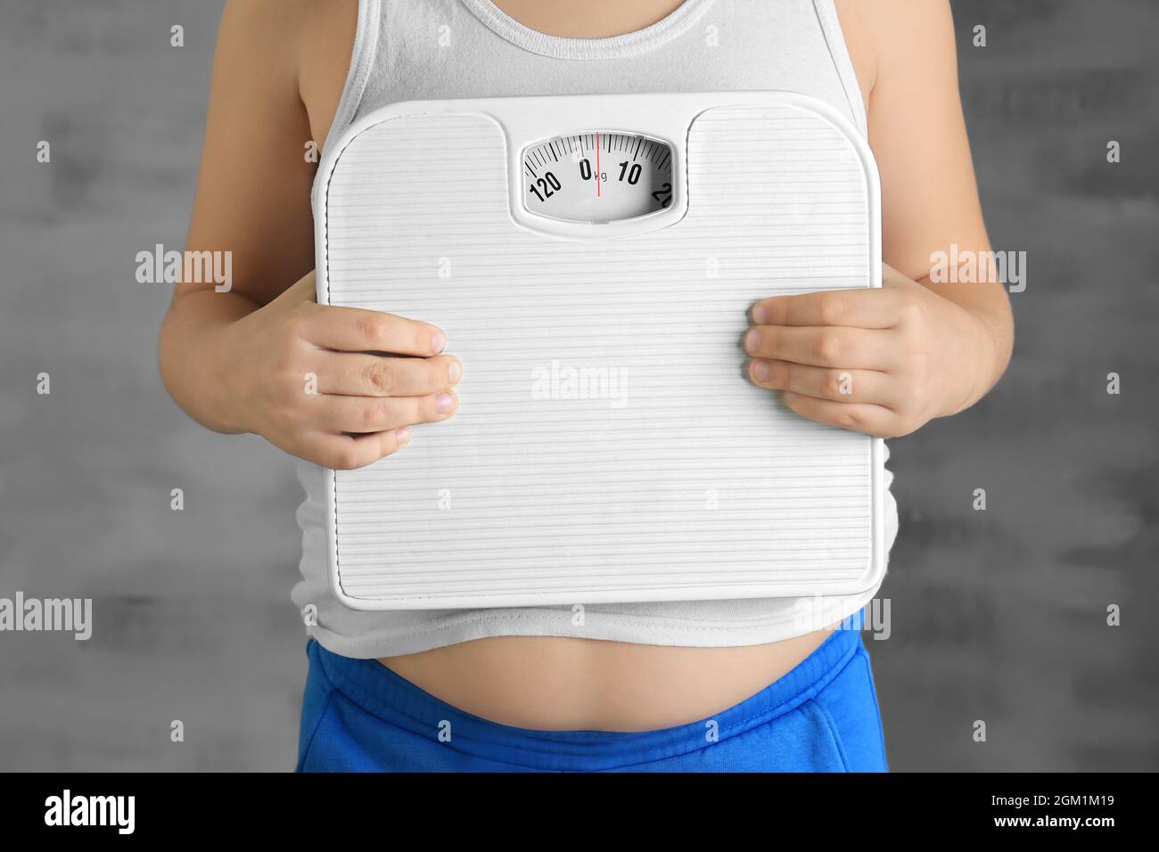 Child obese scales hi-res stock photography and images - Alamy