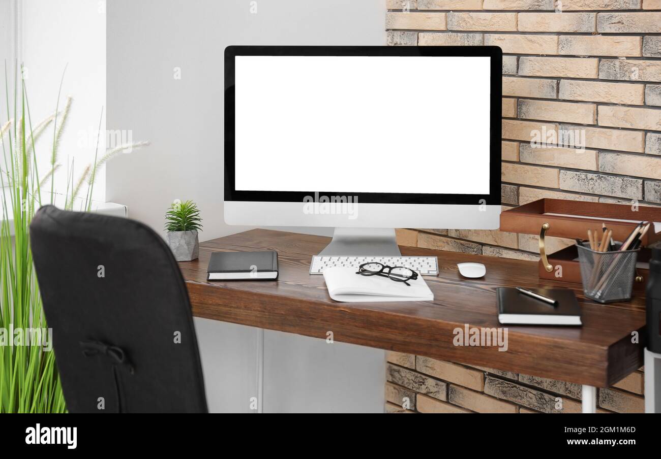 Comfortable workplace with computer monitor on table in office Stock ...