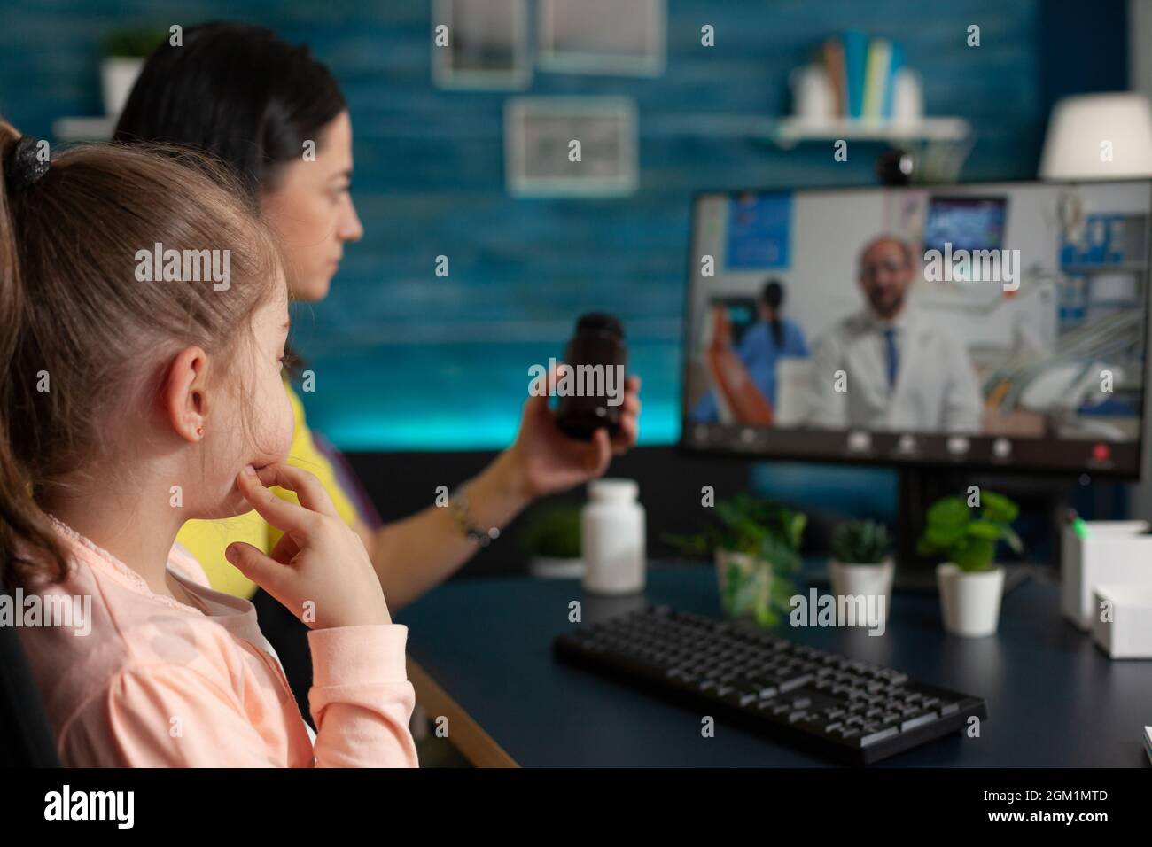 Little girl and mom using telemedicine for consultation with hospital ...