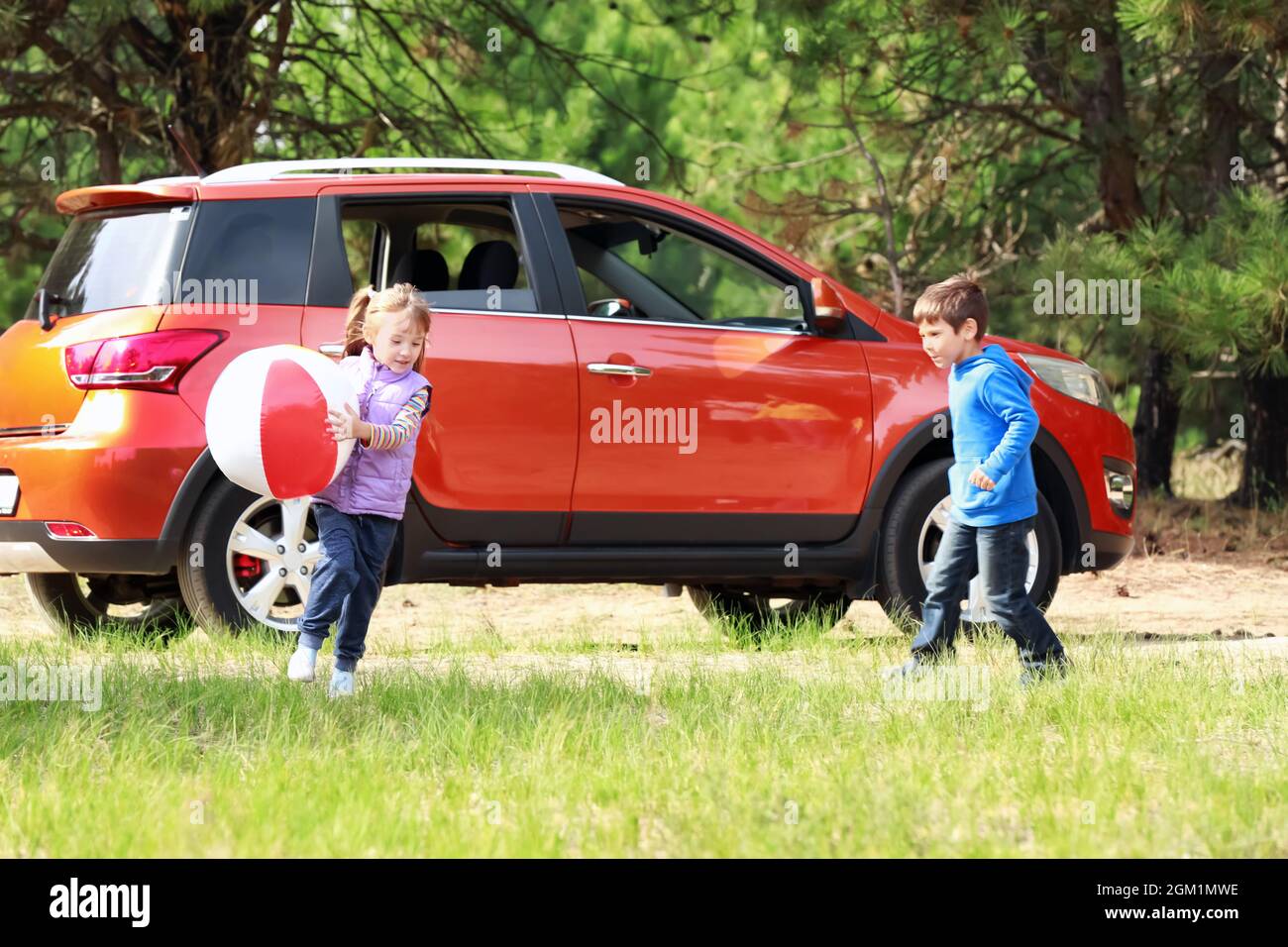 Cute children playing near modern car outdoors Stock Photo - Alamy