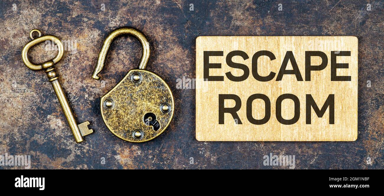 Escape room game concept, old vintage key and padlock on a rusty grunge ...