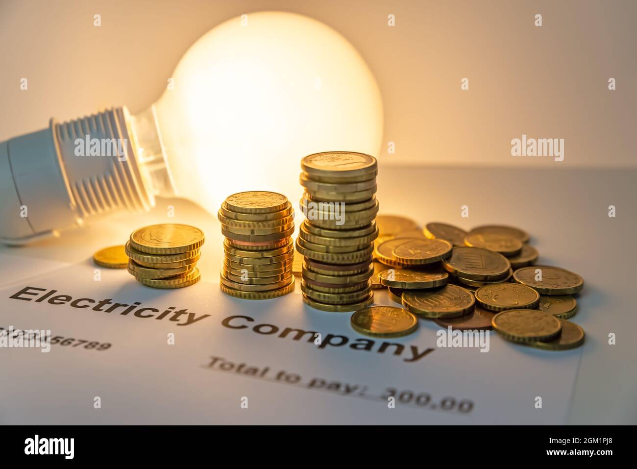 Light bulb on, with banknotes, coins and energy bill. Increase in ...