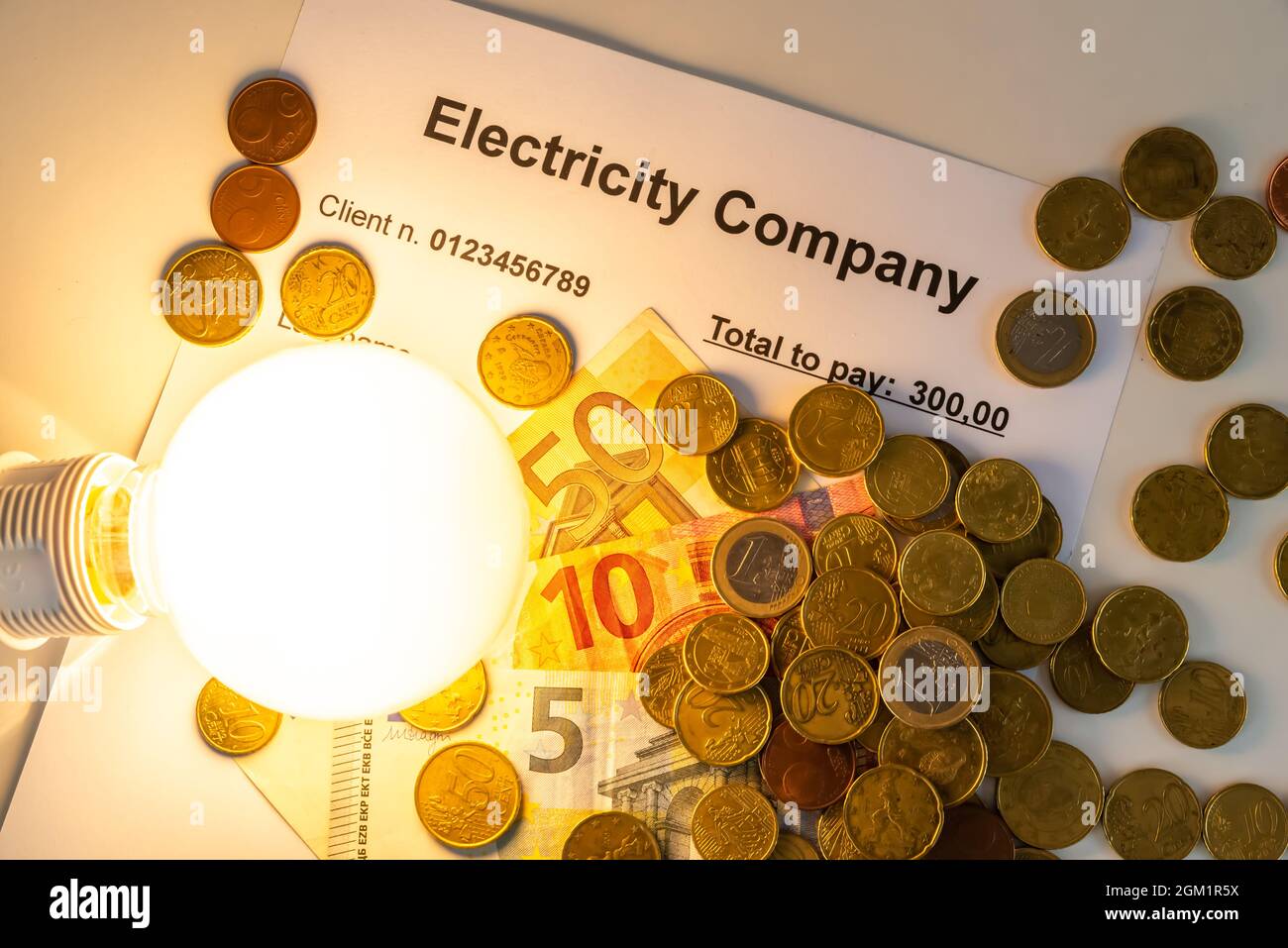 Light bulb on, with banknotes, coins and energy bill. Increase in ...