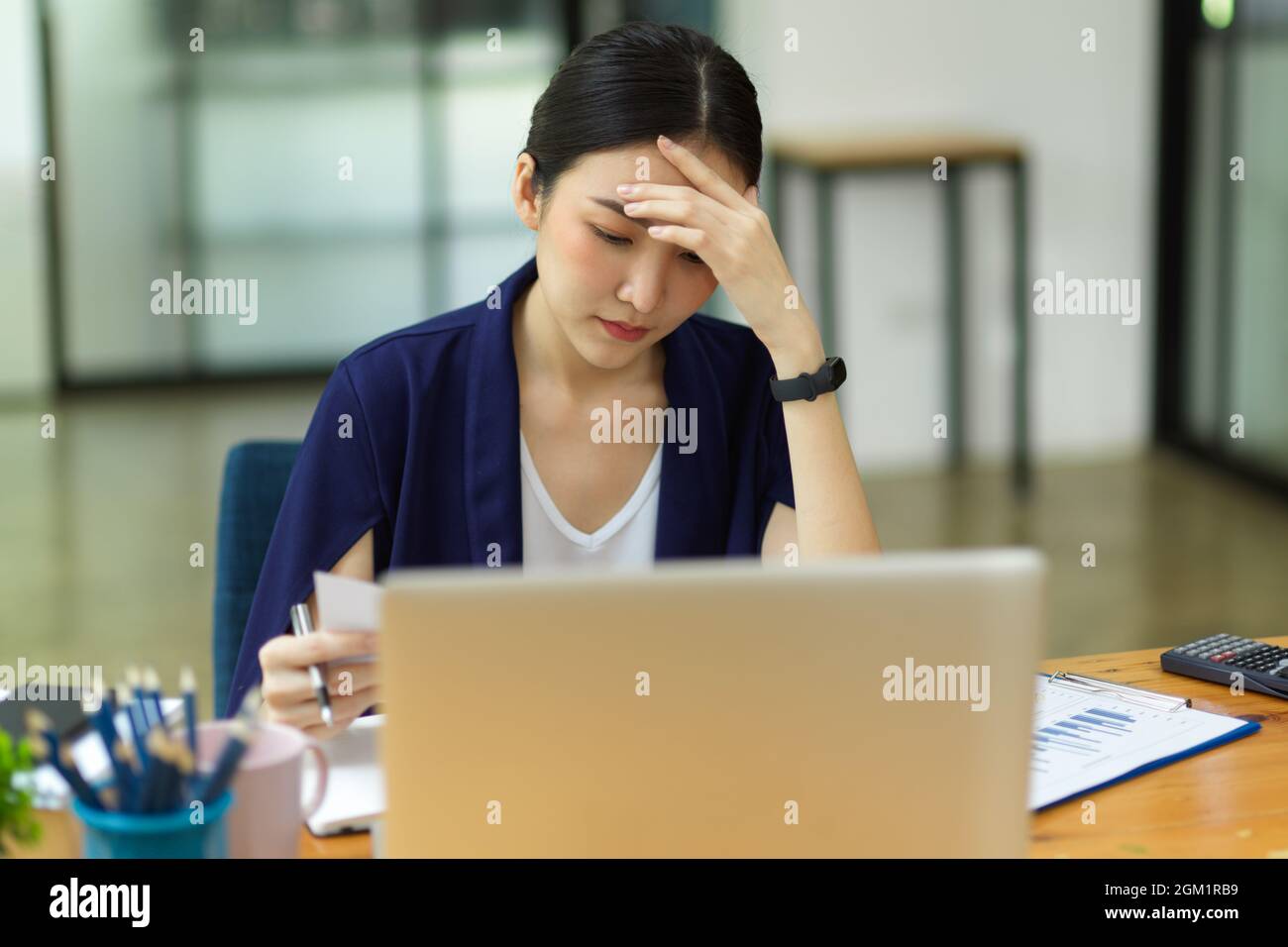 Stressed businesswomen working in office sit in front of laptop ...