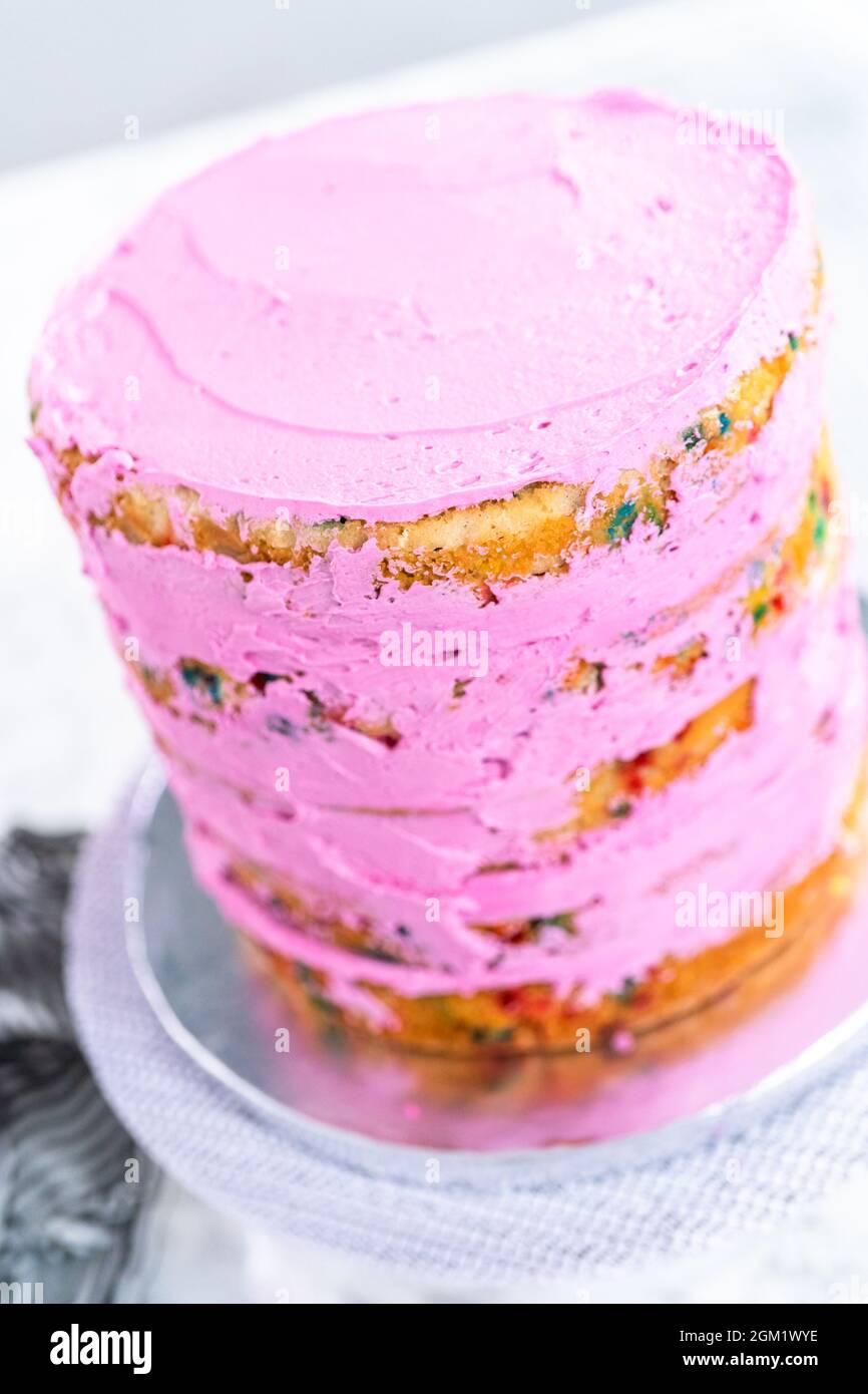 Funfetti cake layers with pink buttercream frosting Stock Photo - Alamy