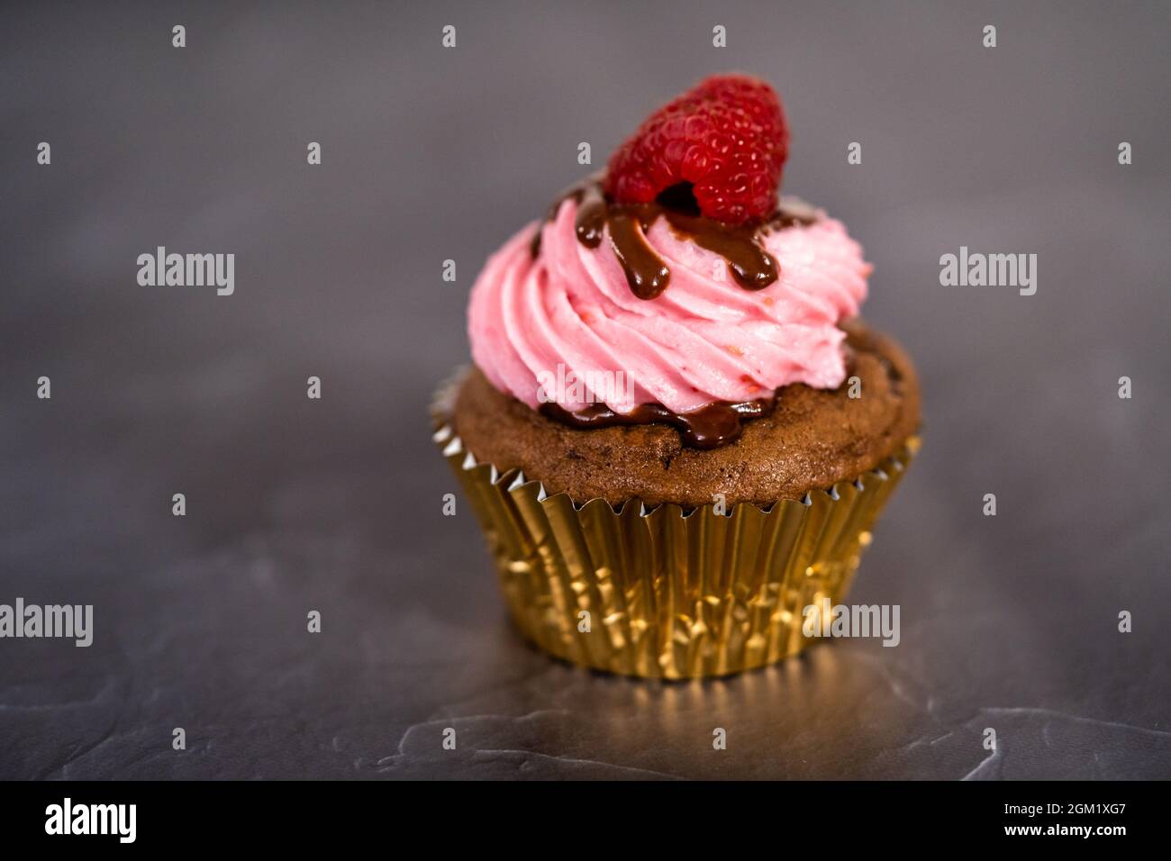 Gourmet chocolate raspberry cupcakes drizzled with chocolate ganache ...