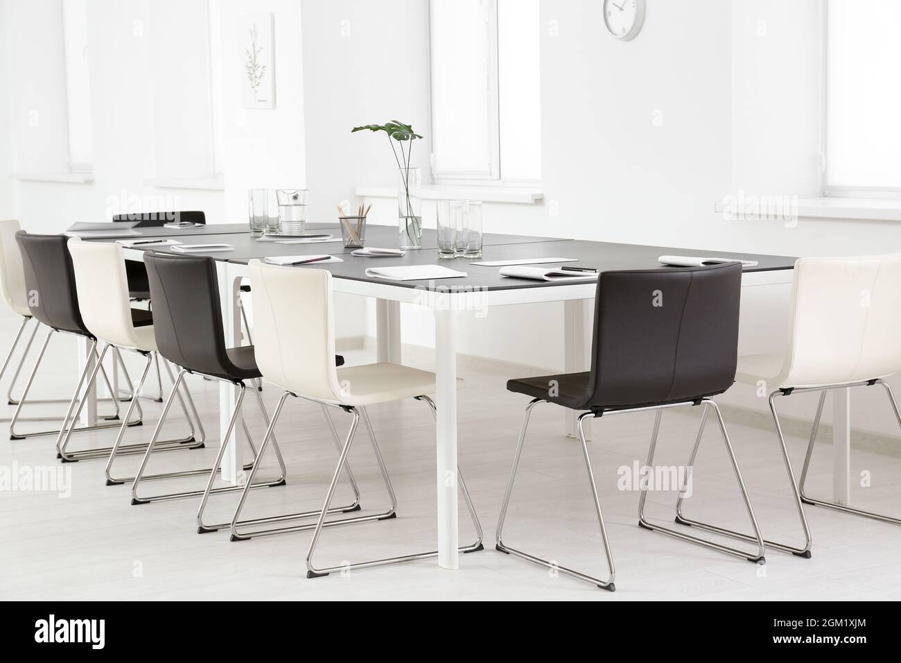 Modern office interior with large table and chairs Stock Photo - Alamy