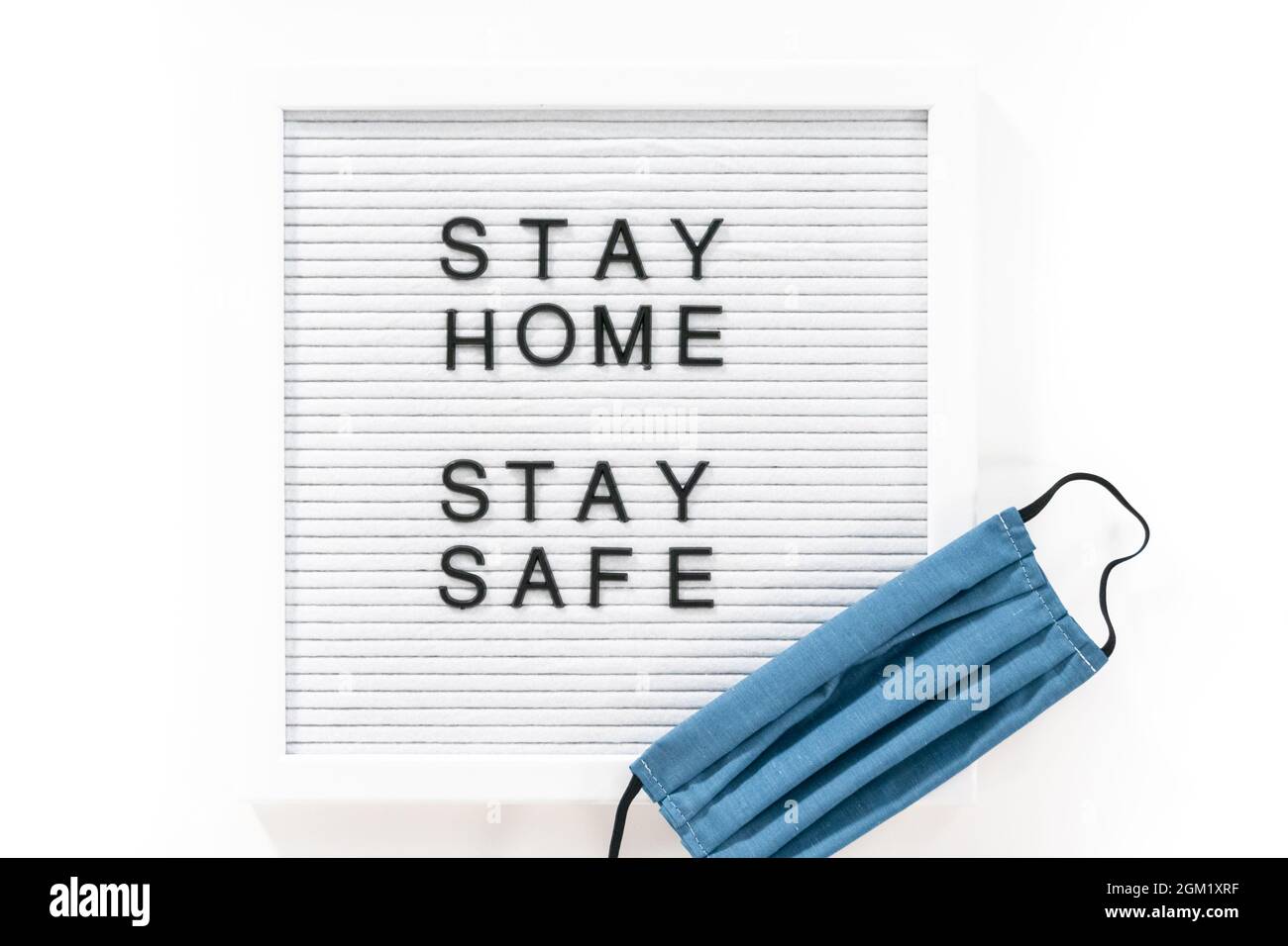 STAY HOME and STAY SAFE sign on message board with a homemade face mask ...