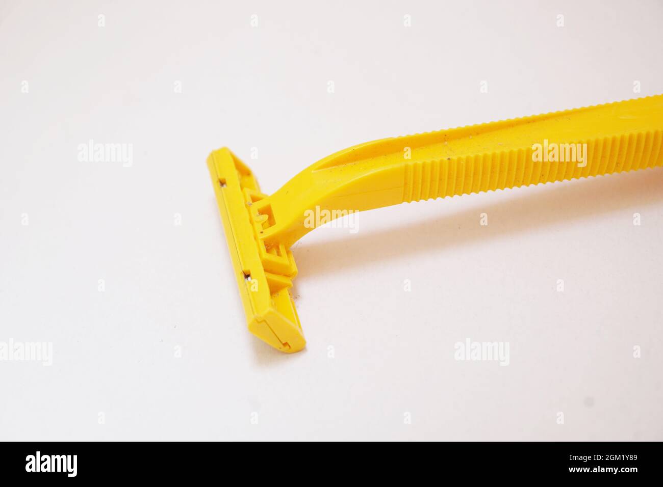 Moustache and beard shaver with used razor blade on an isolated white ...
