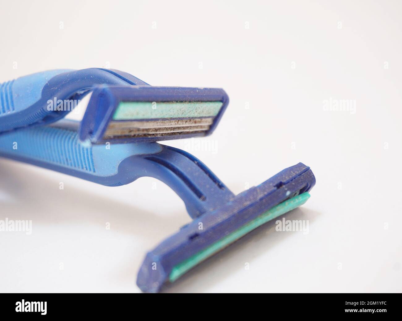 Moustache and beard shaver with used razor blade on an isolated white ...