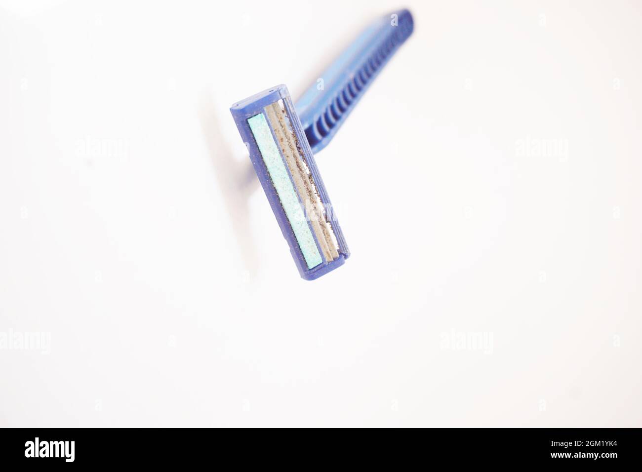 Moustache and beard shaver with used razor blade on an isolated white ...