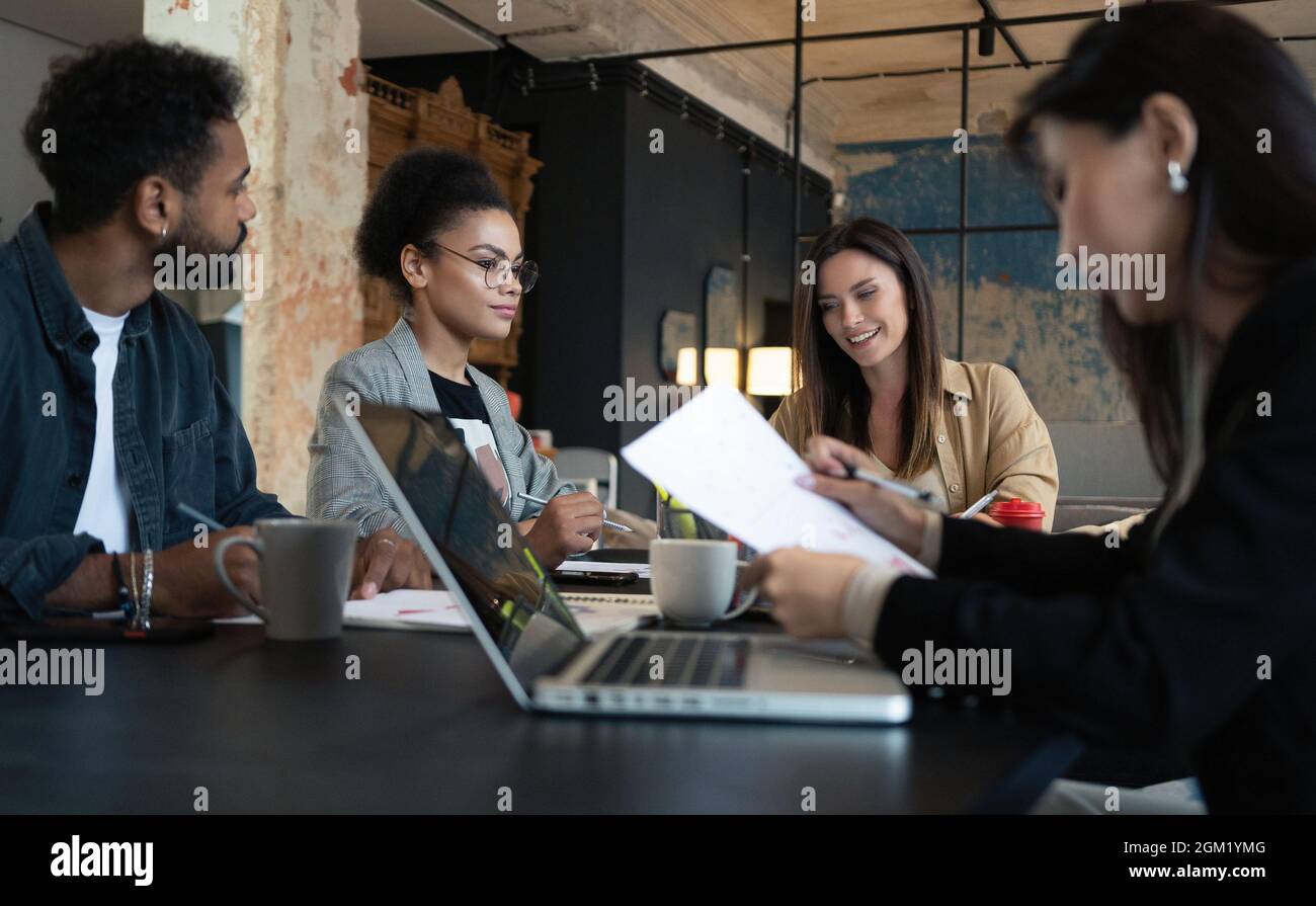 Group of young multiracial people working in modern office. Businessmen ...