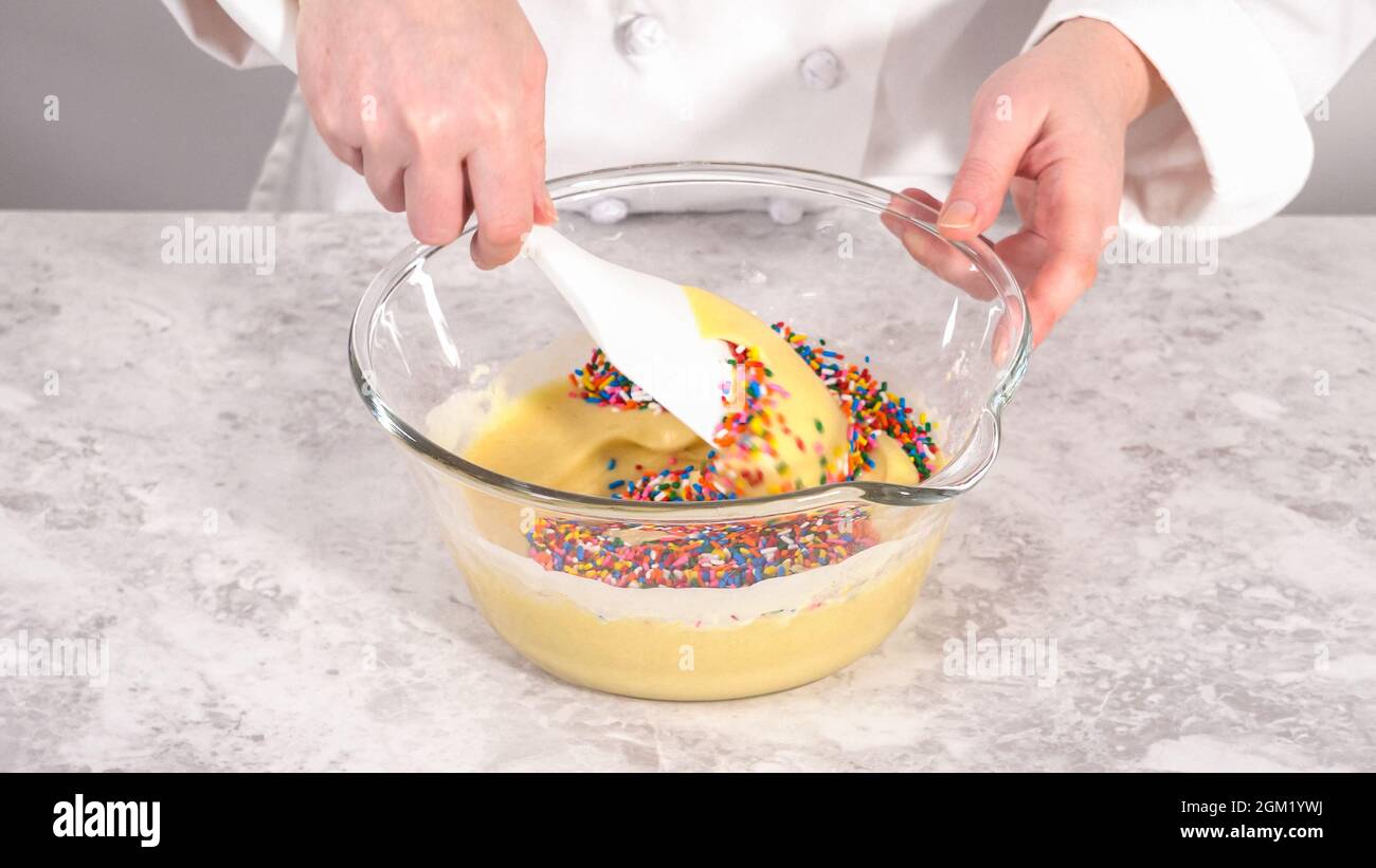 Step by step. Folding into the cake batter rainbow sprinkles to bake ...