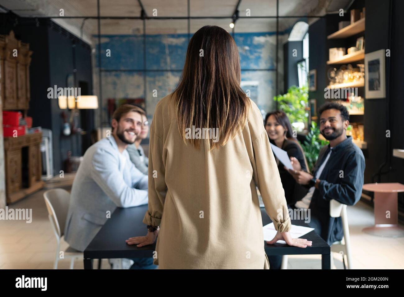 Female executive leader talking to happy diverse employees group at ...