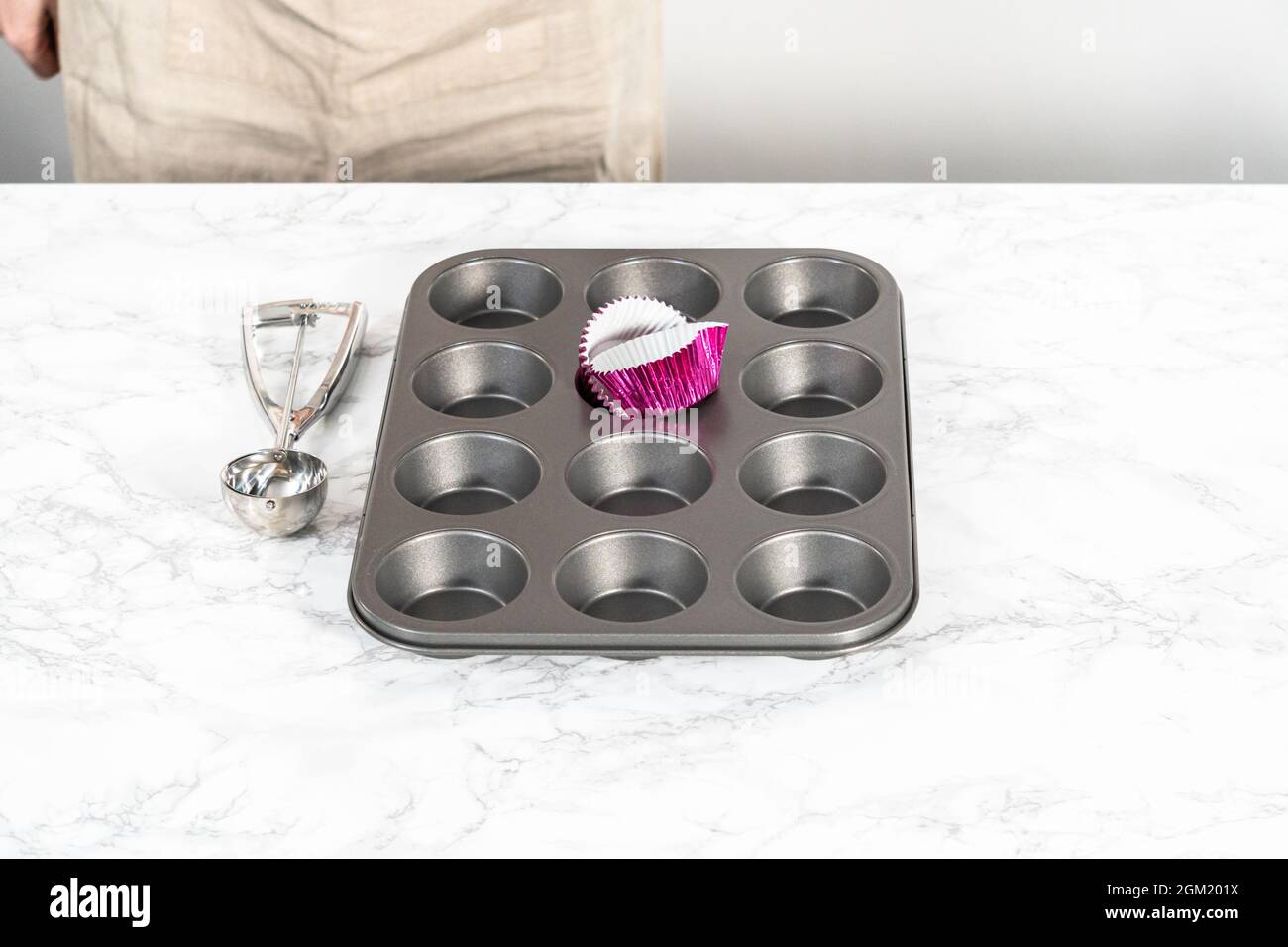 Baking chocolate cupcakes. Lining metal cupcake pan with foil cupcake ...