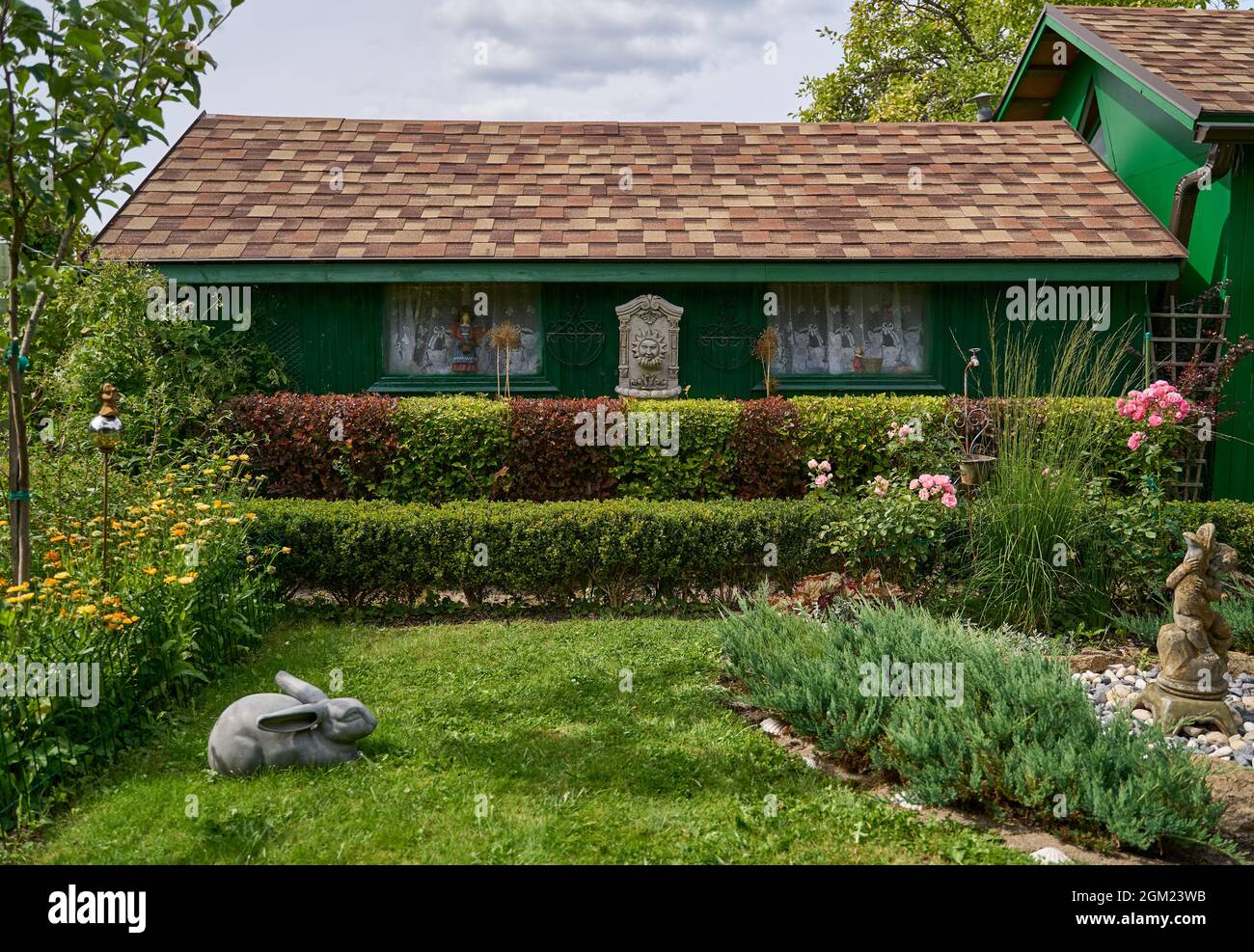 A green cozy barn in the beautiful garden Stock Photo - Alamy