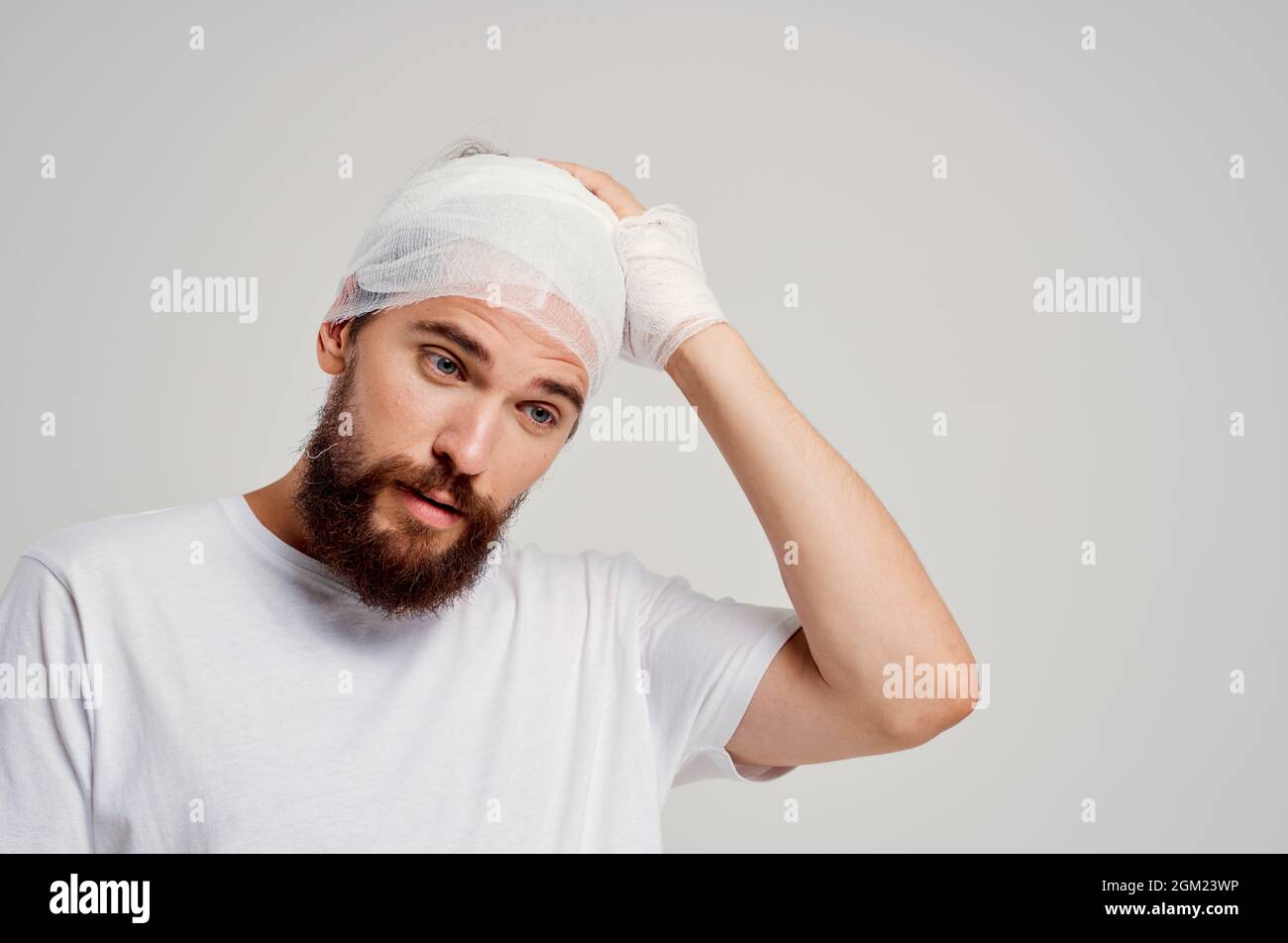 Man bandaged head and hand blood treatment Stock Photo - Alamy