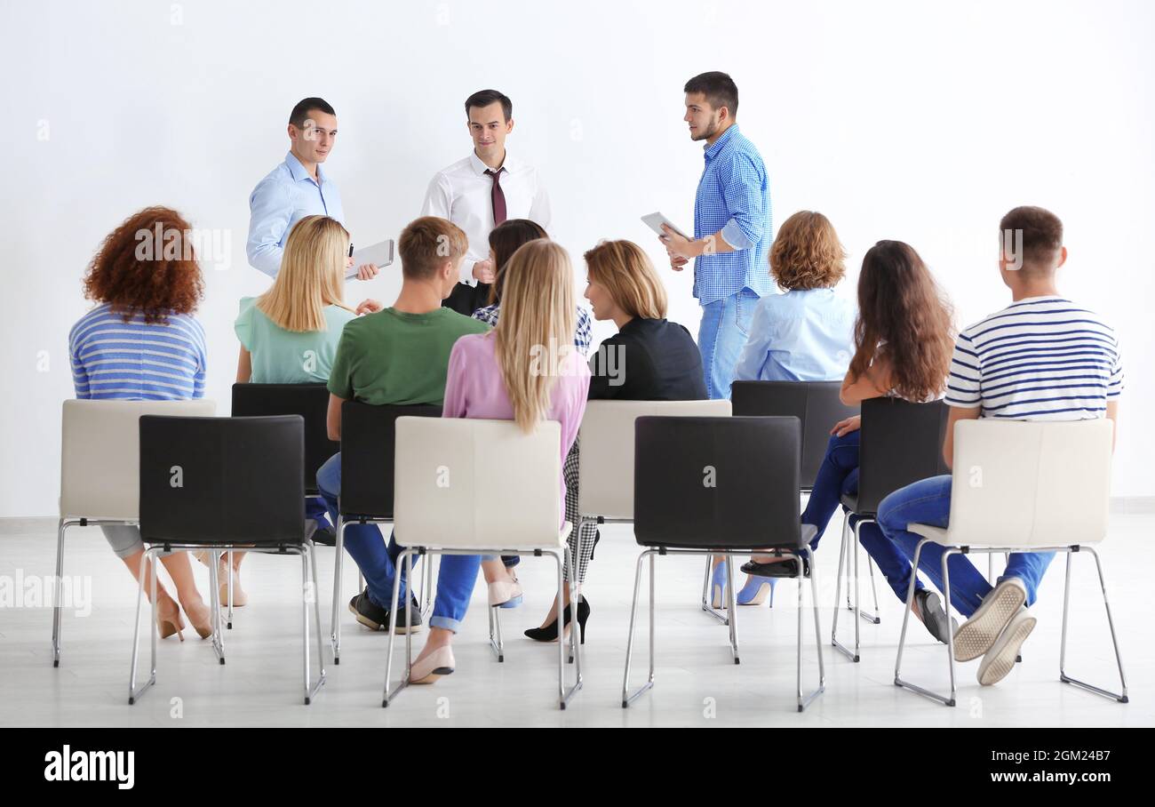 Group of people with business trainer at seminar Stock Photo - Alamy