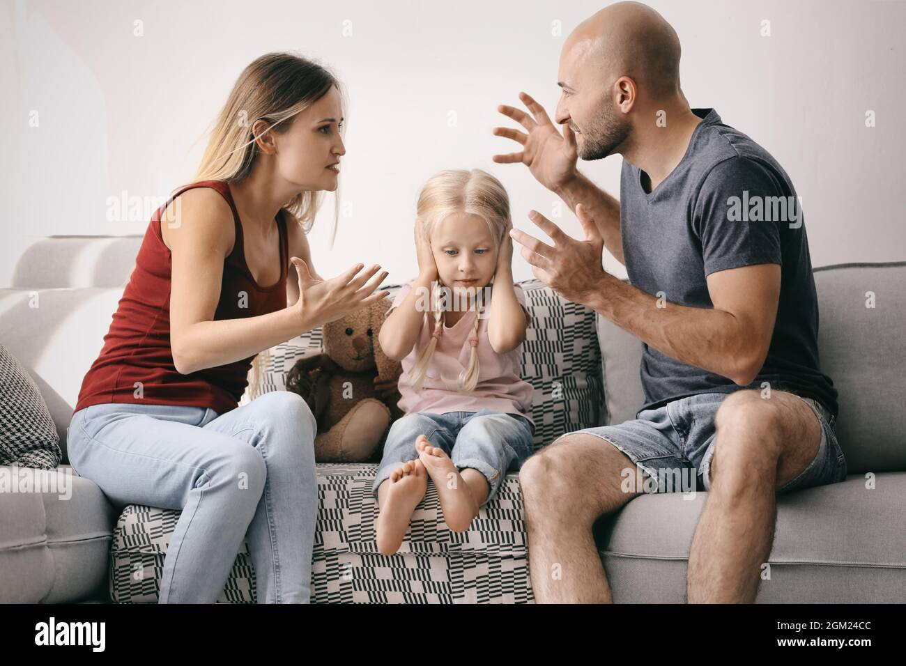 Little girl between arguing parents at home Stock Photo - Alamy