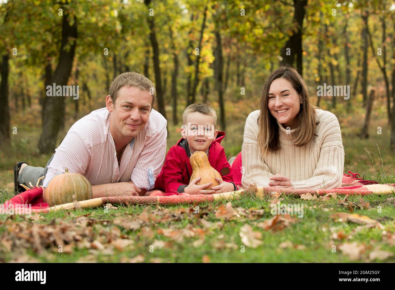 Fall. Close-up of happy family on the background of the autumn forest ...