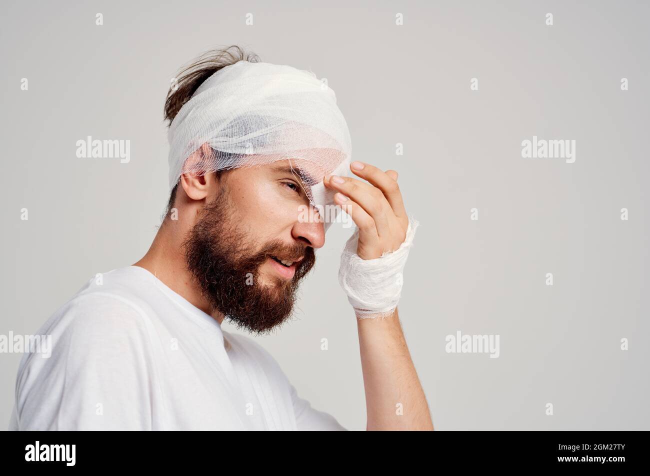 bearded man head injury in white t-shirt headache hospital medicine ...