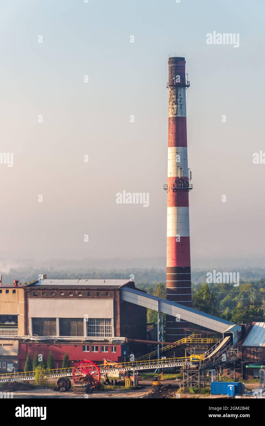 Mine chimney with mine infrastructure. Forests in the background ...