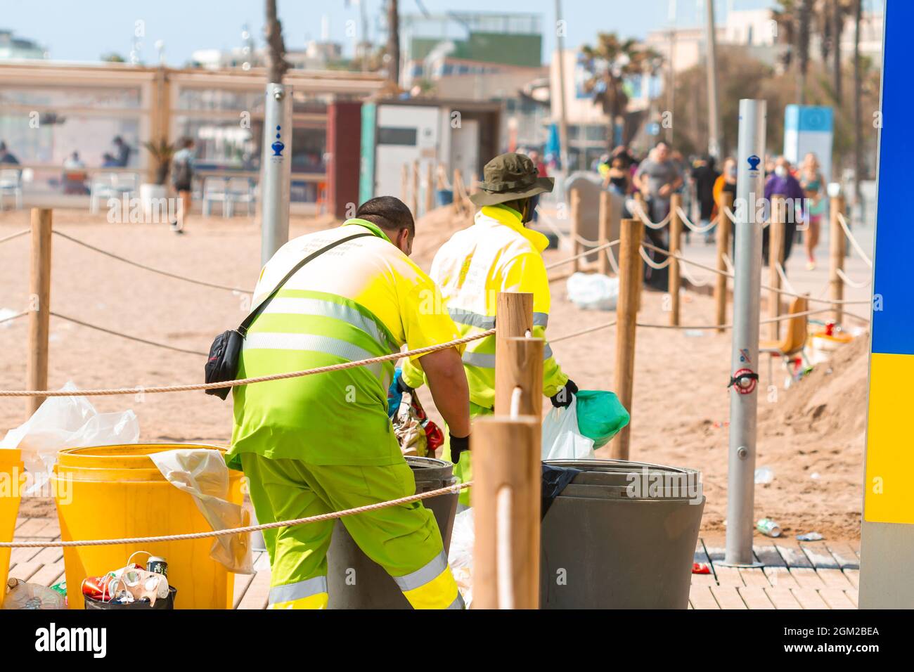 BARCELONA, SPAIN - May 05, 2021: The beach cleanup workers cleaning ...