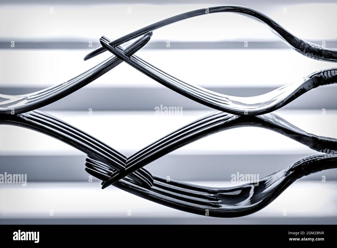 Forks Reflections - Silverware forks create shapes and reflections ...