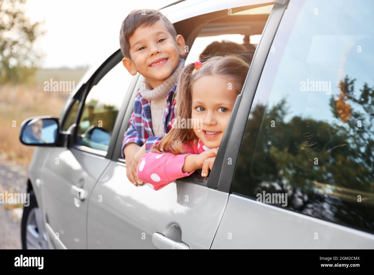 Cute children in car Stock Photo - Alamy