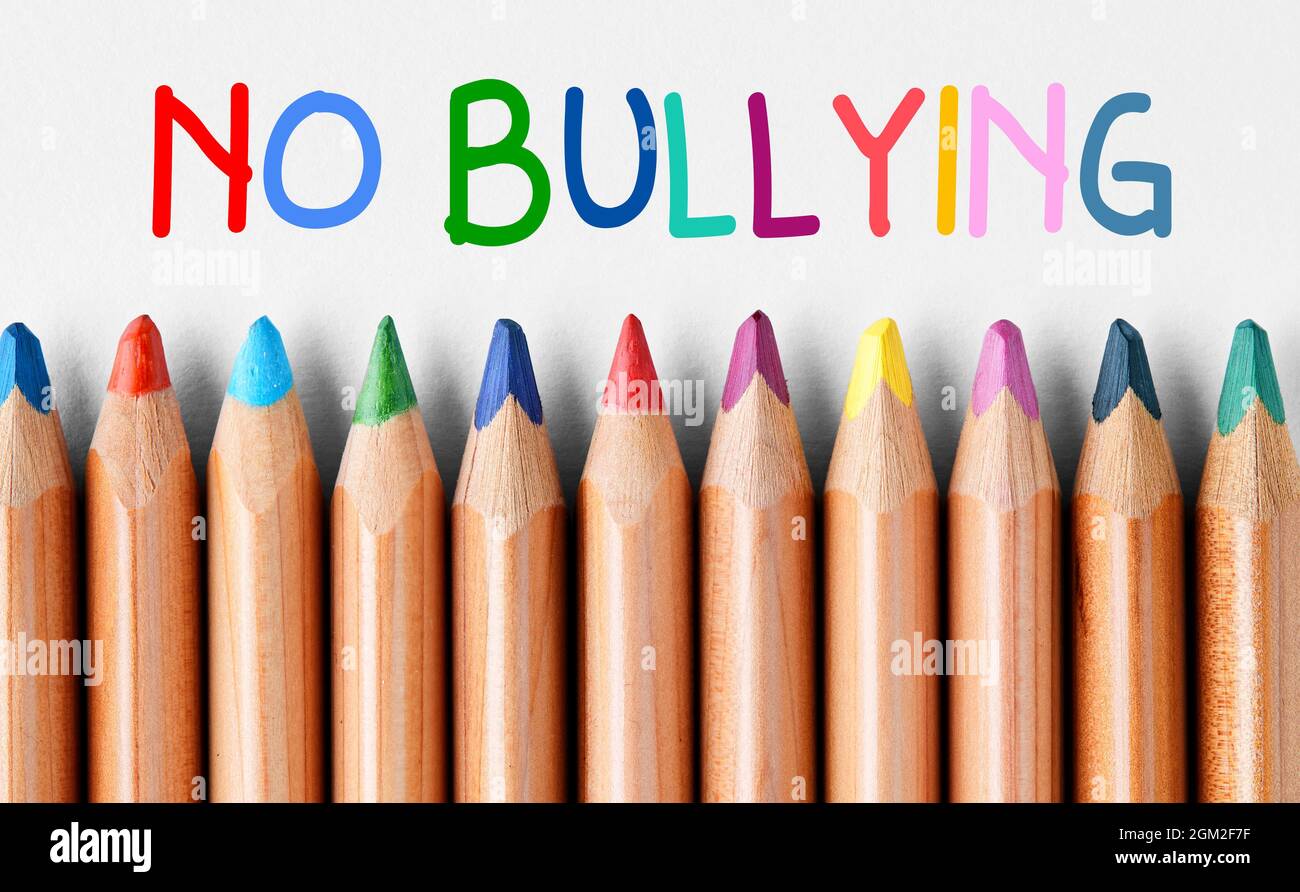 Colorful wooden crayon pencils in a row with no bullying message ...