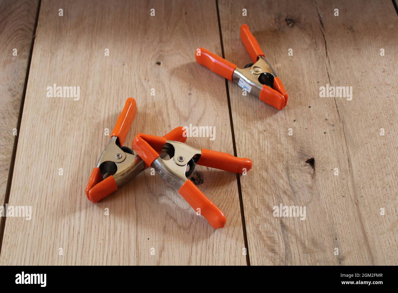 Three Simple Orange Construction Clamps Stock Photo - Alamy