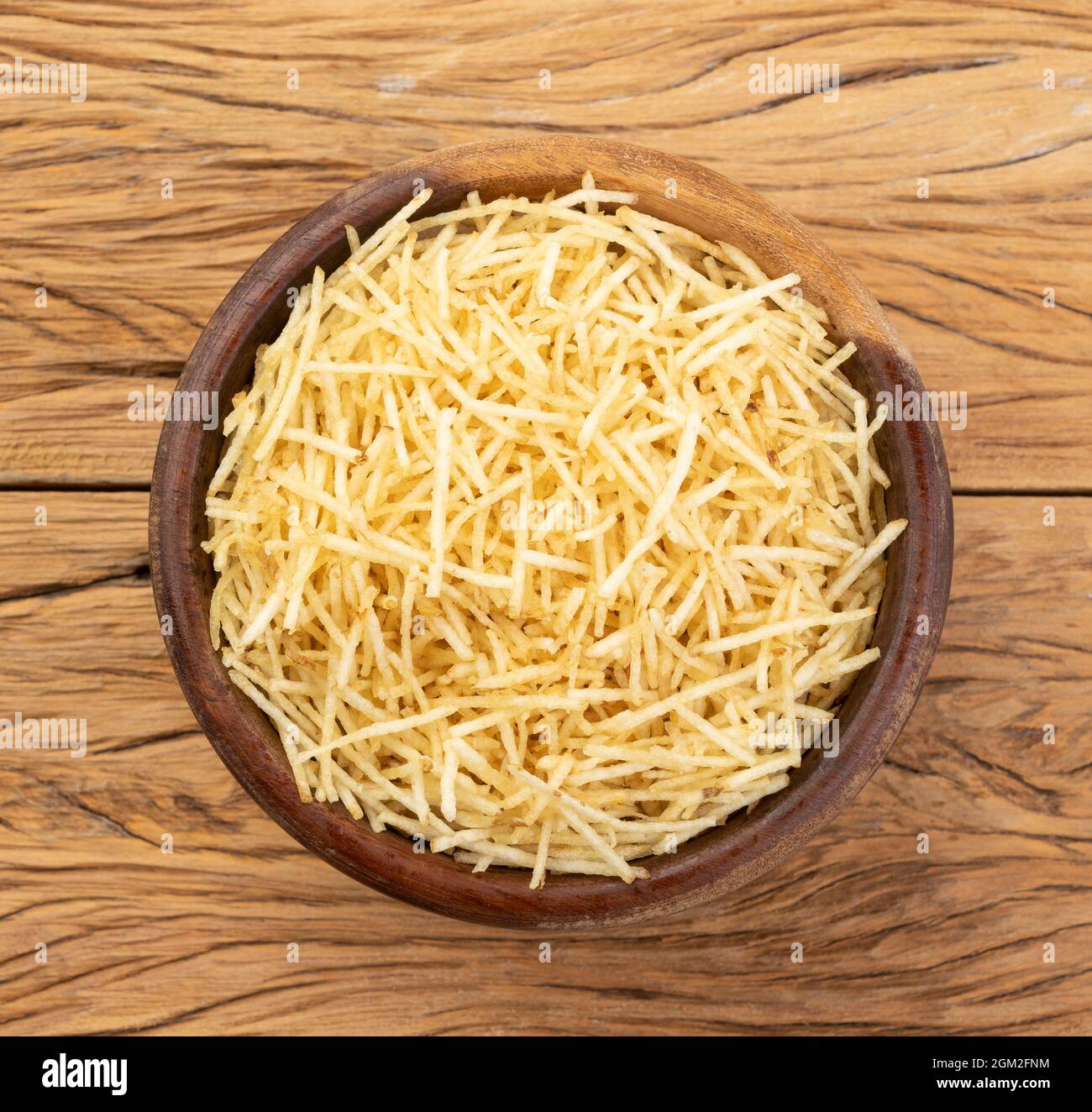 Potato straw or shoestring potato in a bowl over wooden table Stock ...