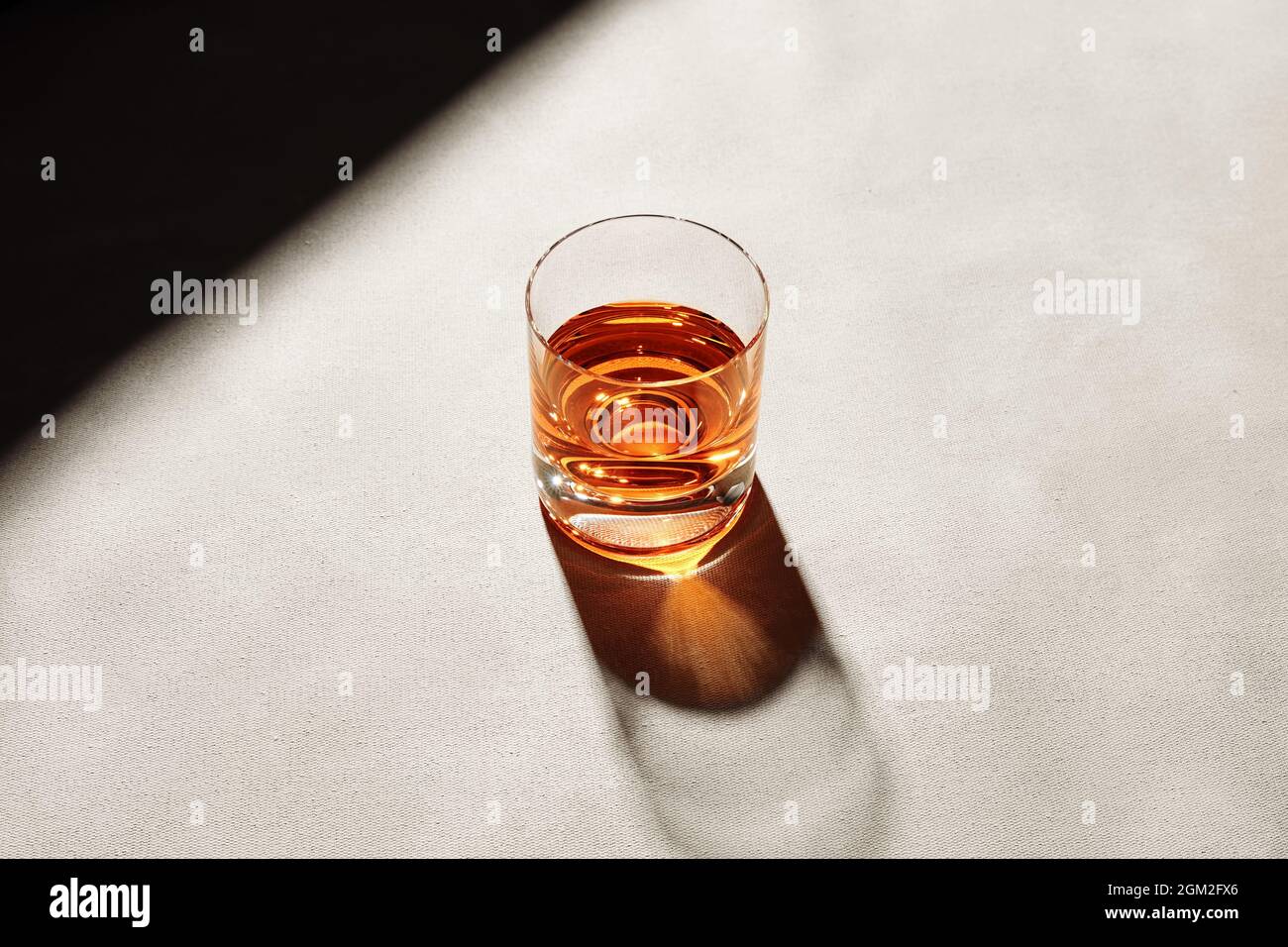 Glass of elegant straight or neat whiskey on a bar counter with dark ...