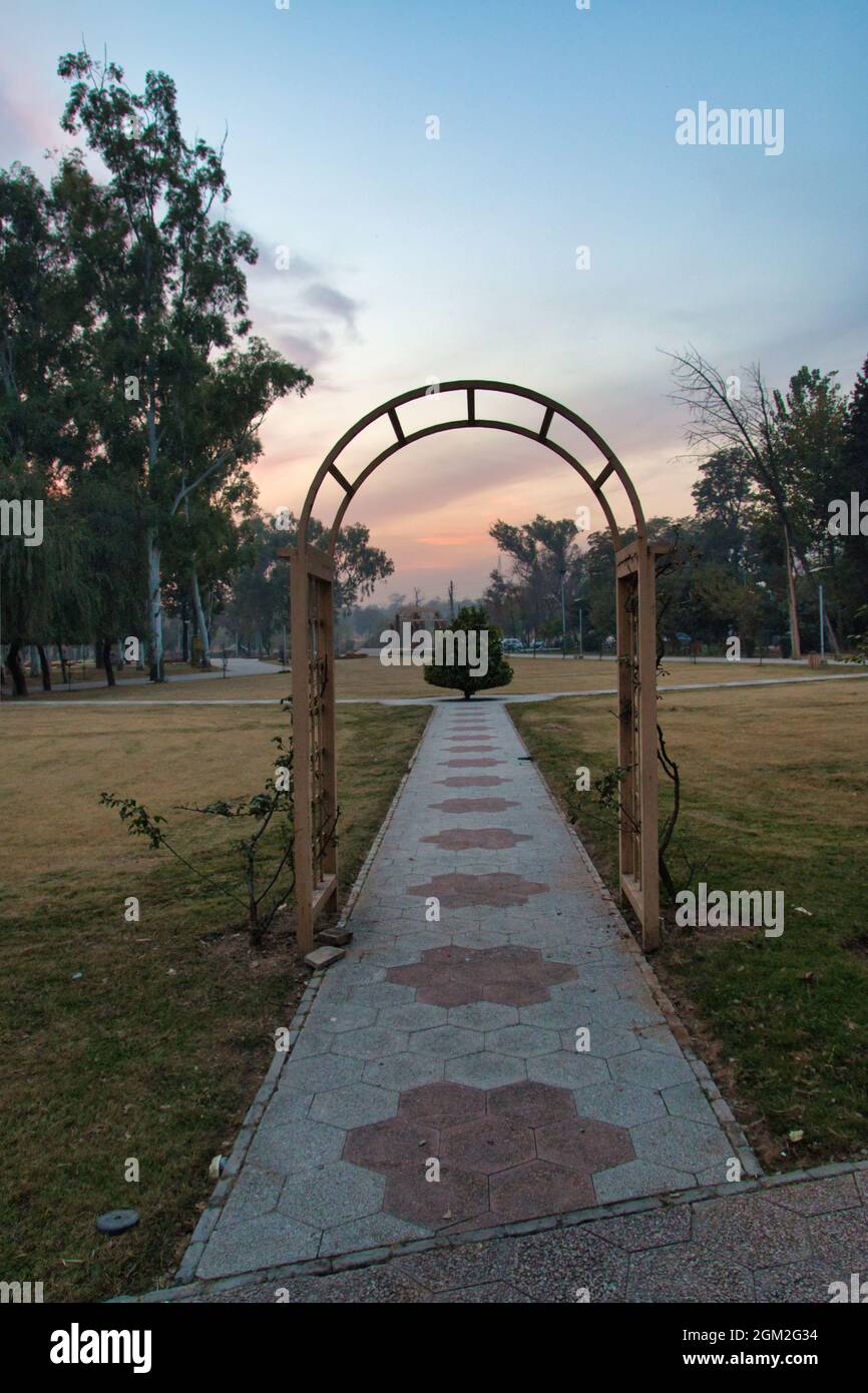 An arc in the garden over a pathway Stock Photo - Alamy