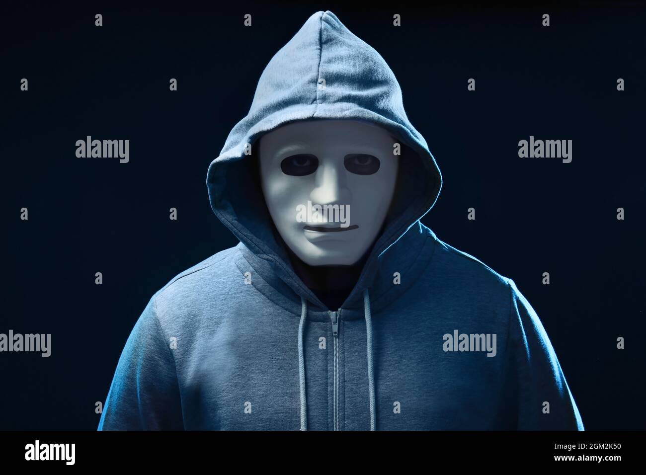 Hacker in mask on dark background Stock Photo - Alamy
