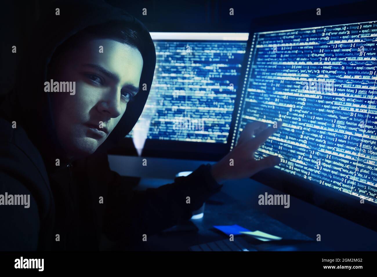 Hacker using computer in dark room Stock Photo - Alamy