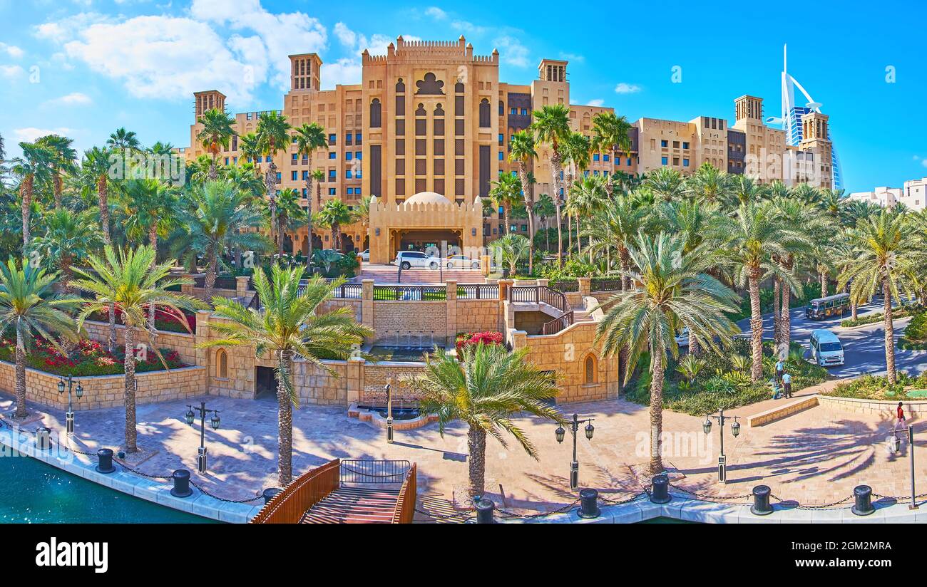 Traditional castle-like building of Mina A'Salam hotel behind the canal ...