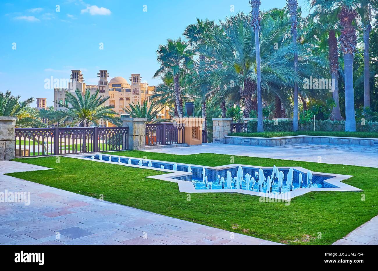 The scenic stellar shaped fountain, surrounded with green lawn with a ...