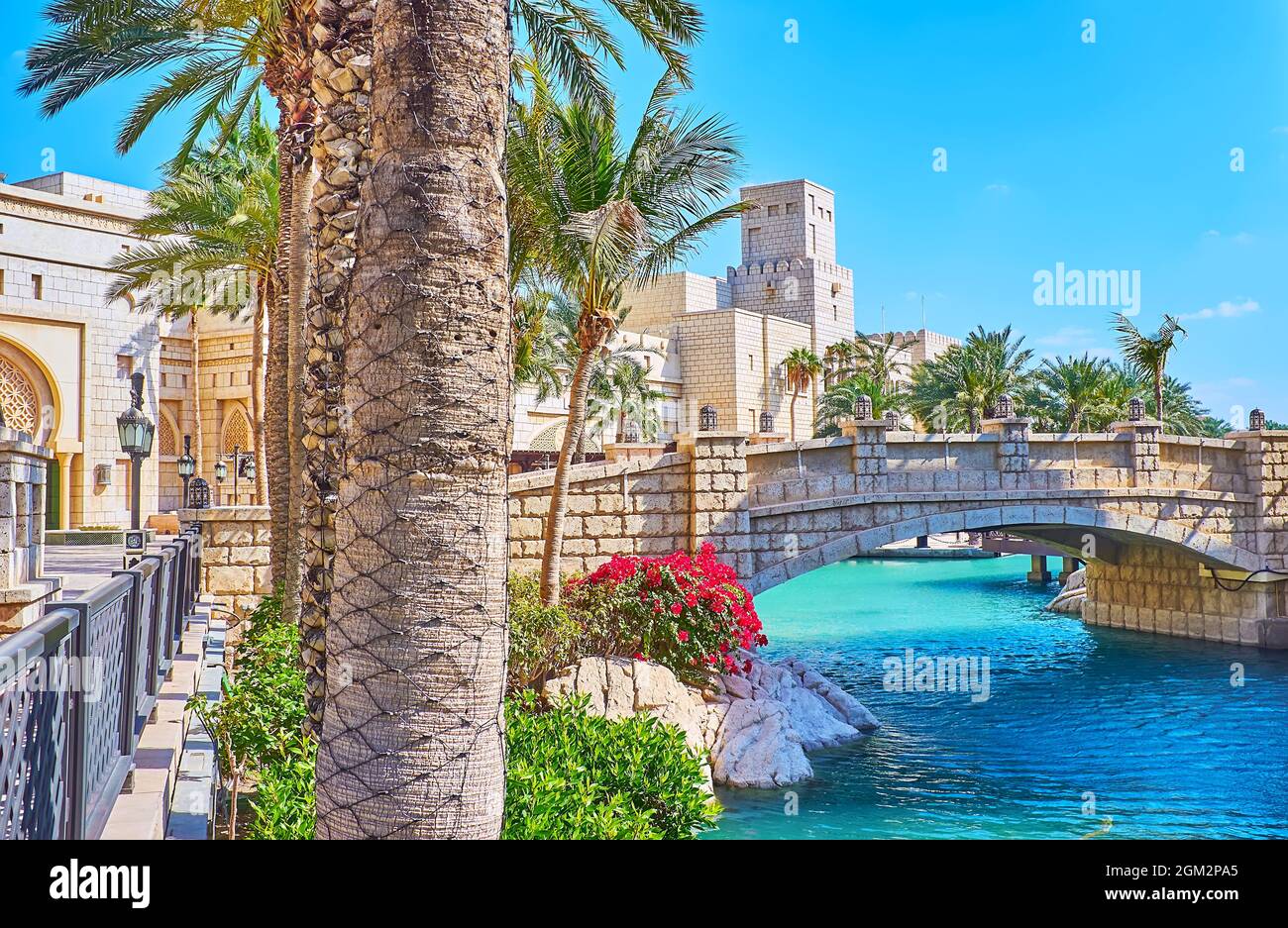 The small stone bridge across the canal with a view of Madinat Arena in ...