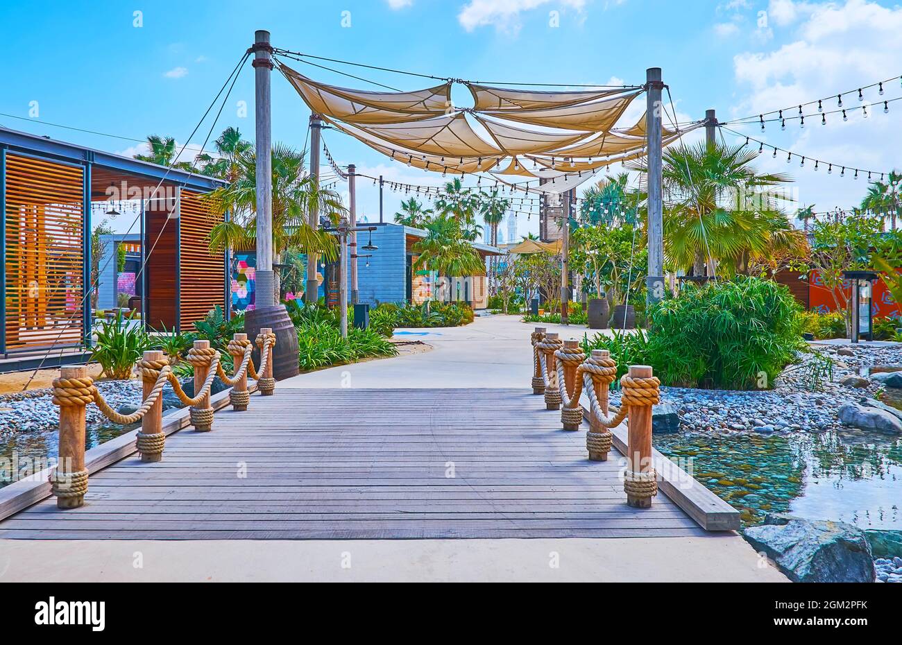 Pedestrian alleyway, decorated with garlands of lamps, sail-like awning ...