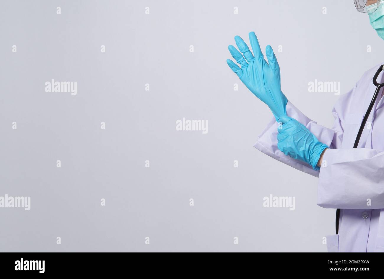 Wearing gloves. Asian doctor wear blue rubber nitrile hands glove. Doc ...