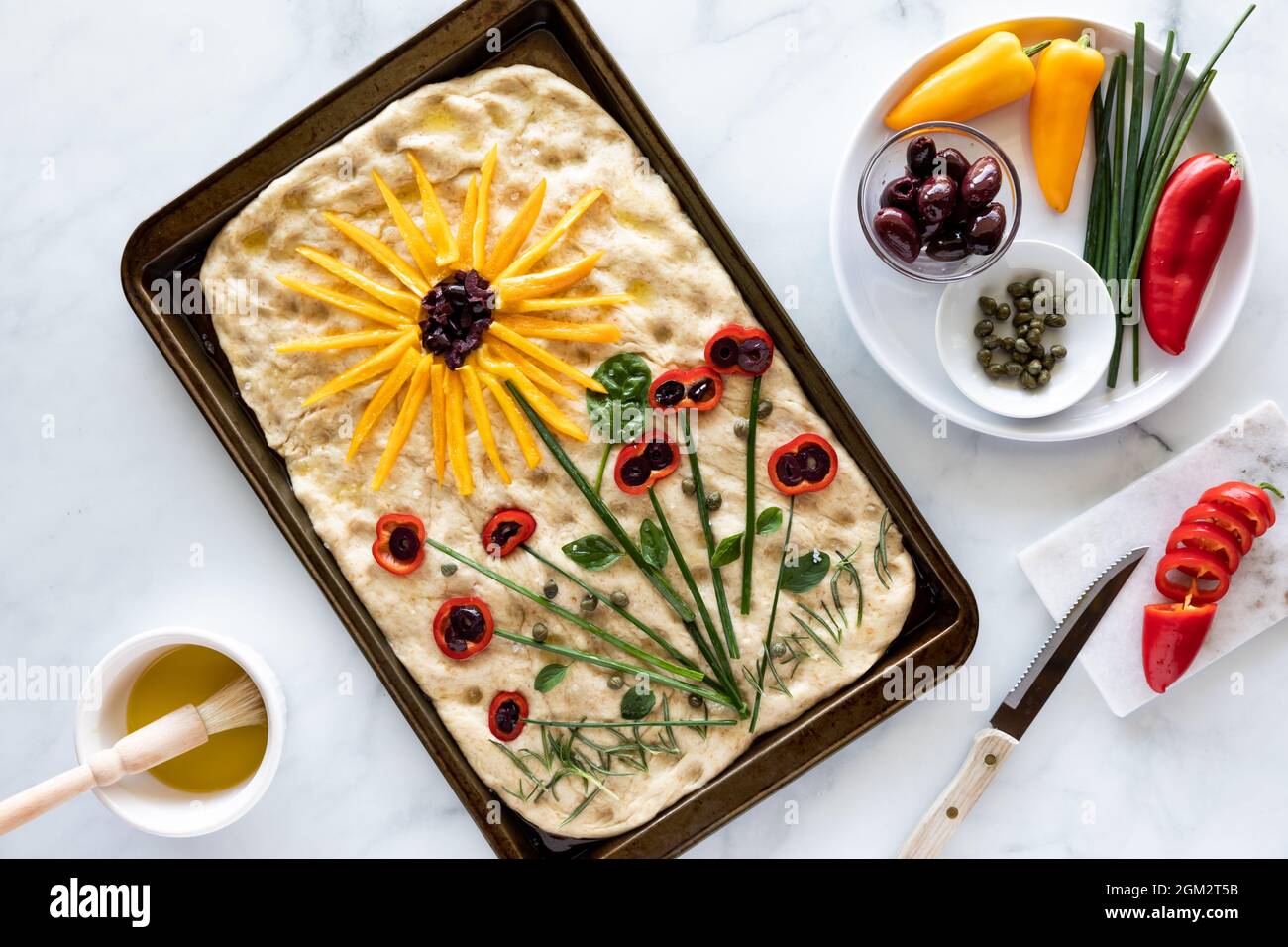 Top down view of a homemade artistic focaccia bread using vegetables ...