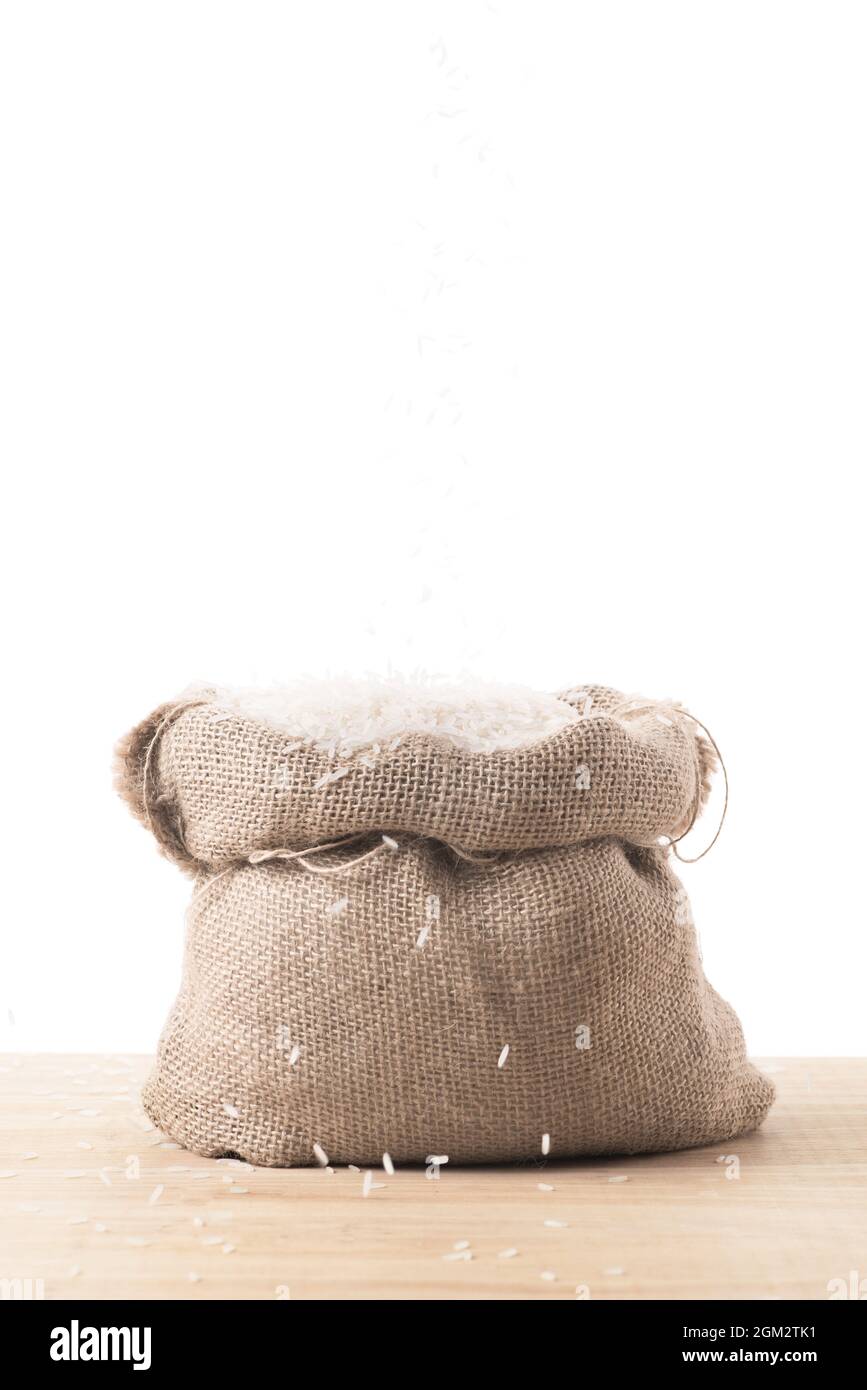 White rice in burlap sack bag isolated on white background Stock Photo ...