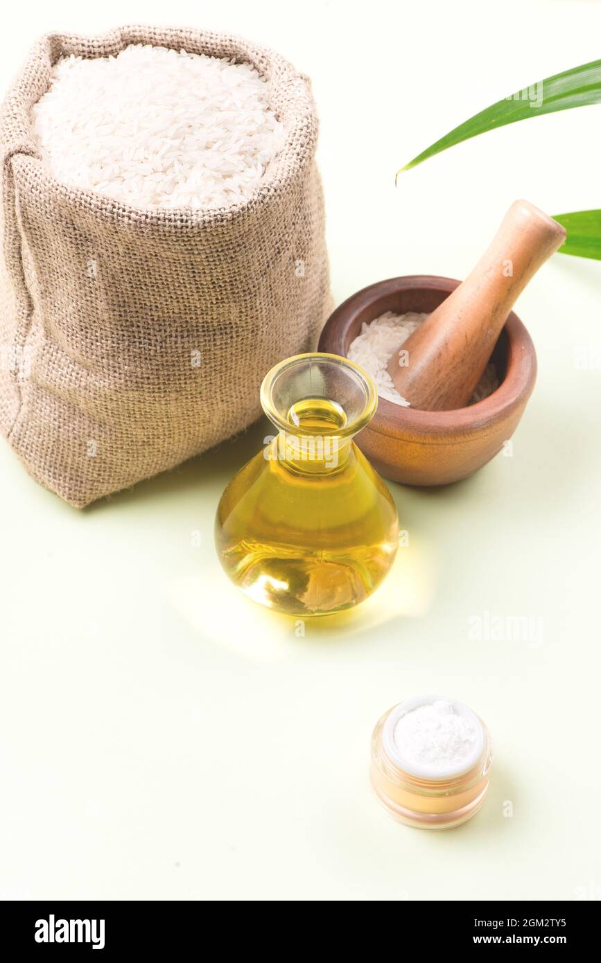 Rice bran oil extract and brown rice on wood table background Stock ...