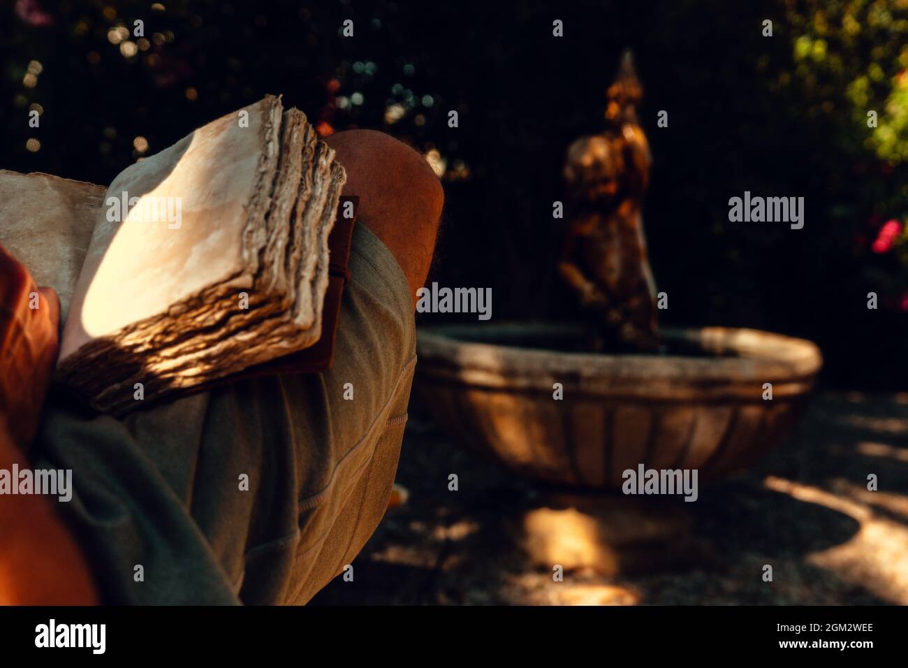 Selective of a man's hand drawing a park landscape in an old notebook ...