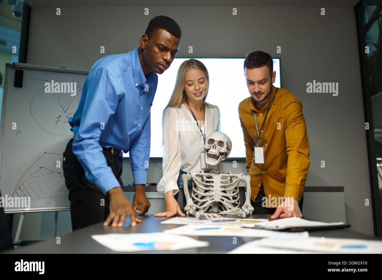 Funny managers and skeleton in IT office, joke Stock Photo - Alamy